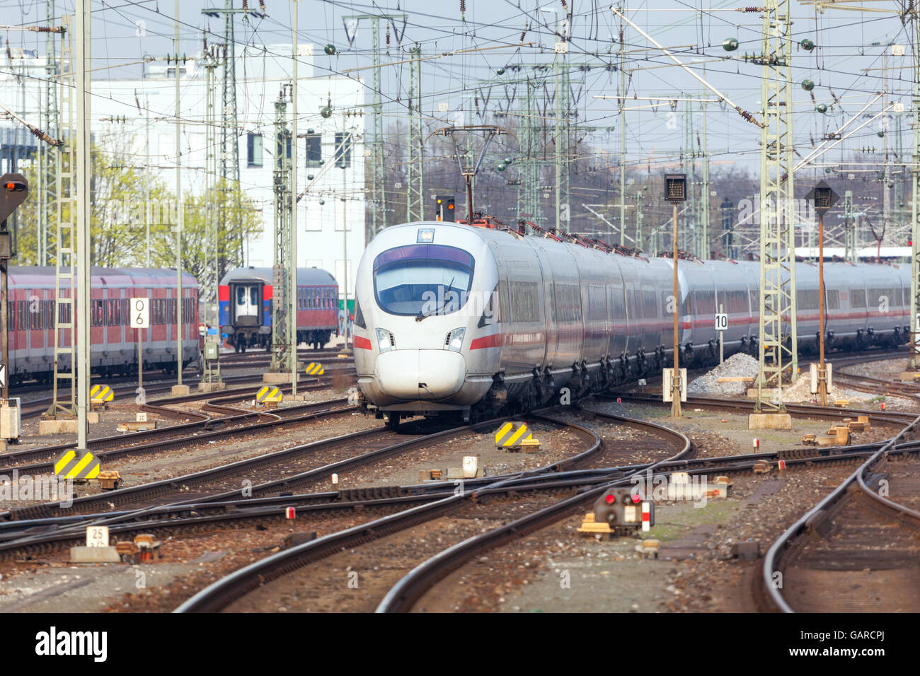 Railway station with modern high speed train in motion in the evening ...