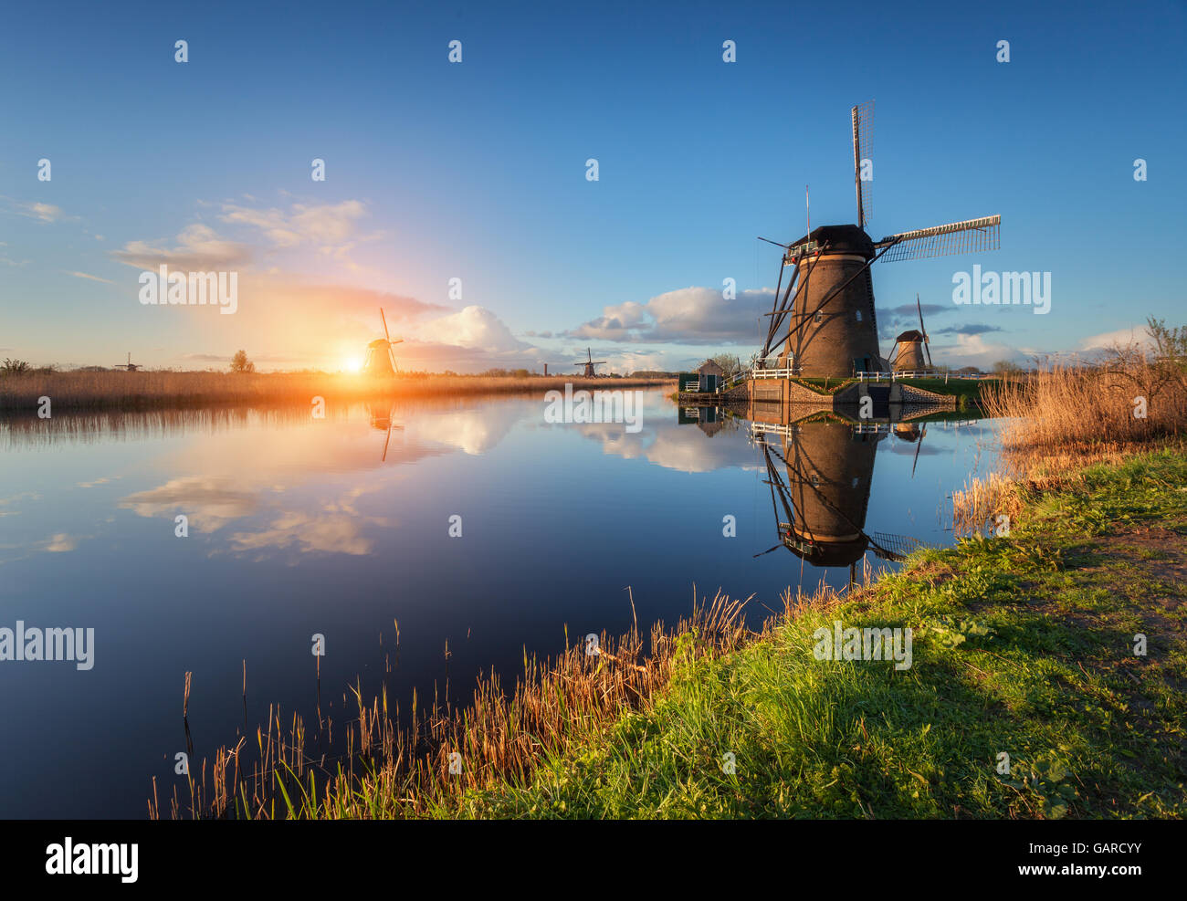 Beautiful traditional dutch windmills near the water channels with ...