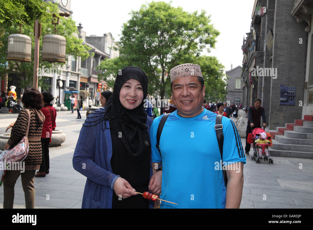 Muslim Chinese people, man and his wife who wears a hijab both smile ...
