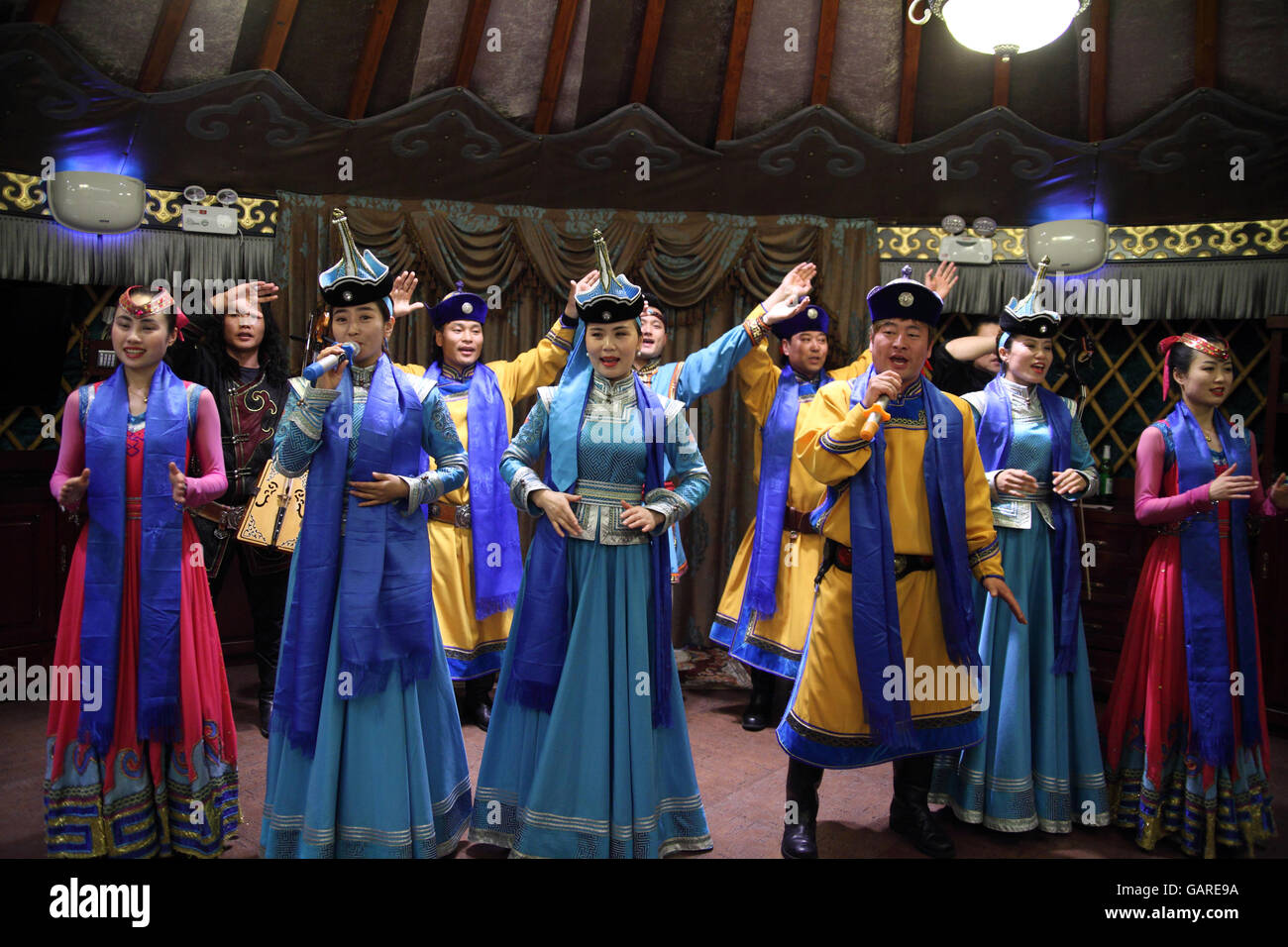 Mongolian dancers and singers, men and women, wear Mongolian costumes ...