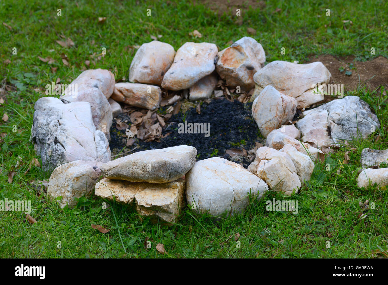 Open fire outdoors. Chic bonfire topped with stones in nature Stock ...