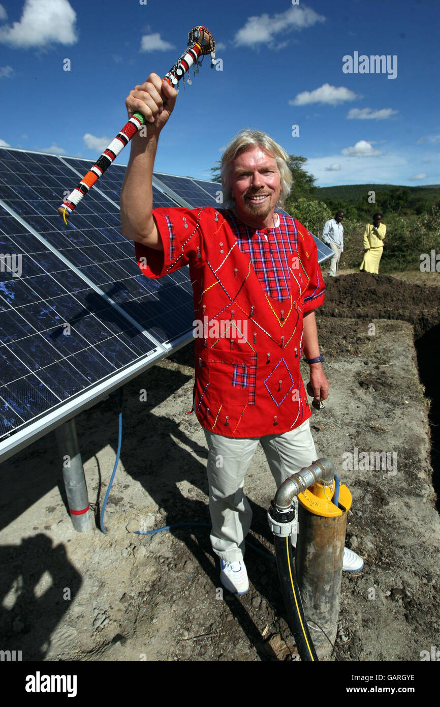 Sir Richard Branson stands in front of the solar paneled that has been ...
