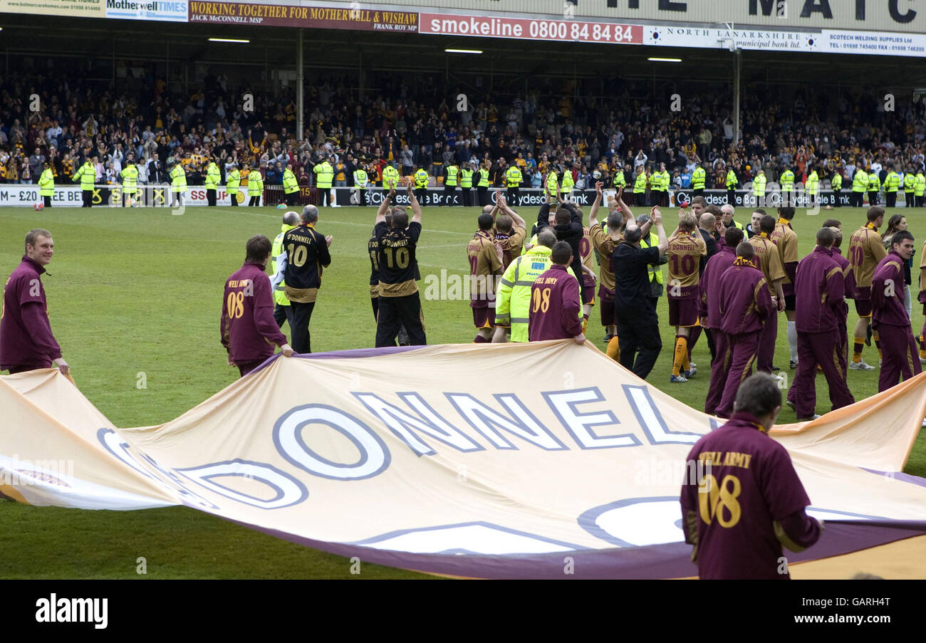 Motherwell players parade for their fans as they walk in front of a ...