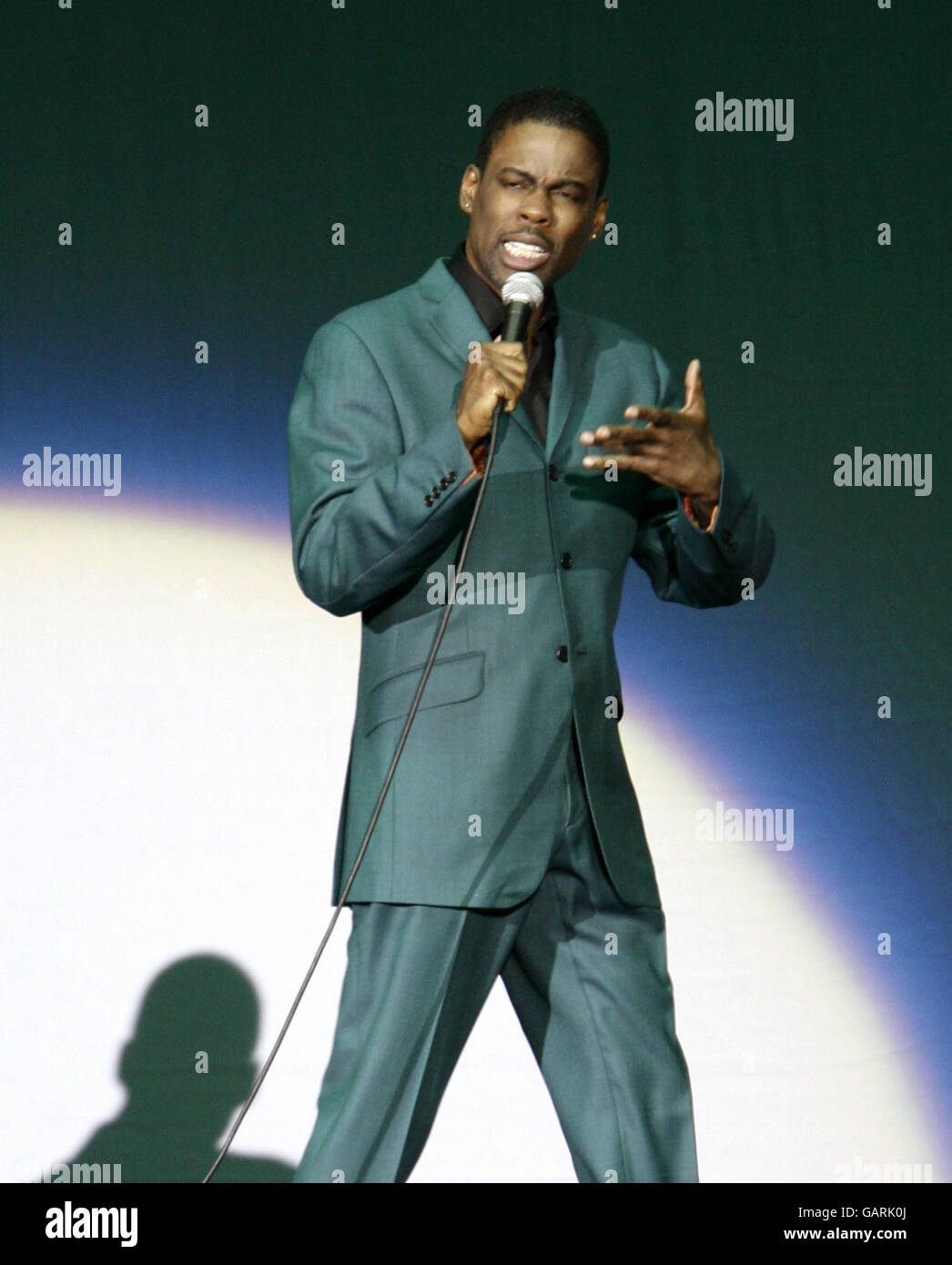 Celebrity gestures microphone on stage performing hi-res stock ...