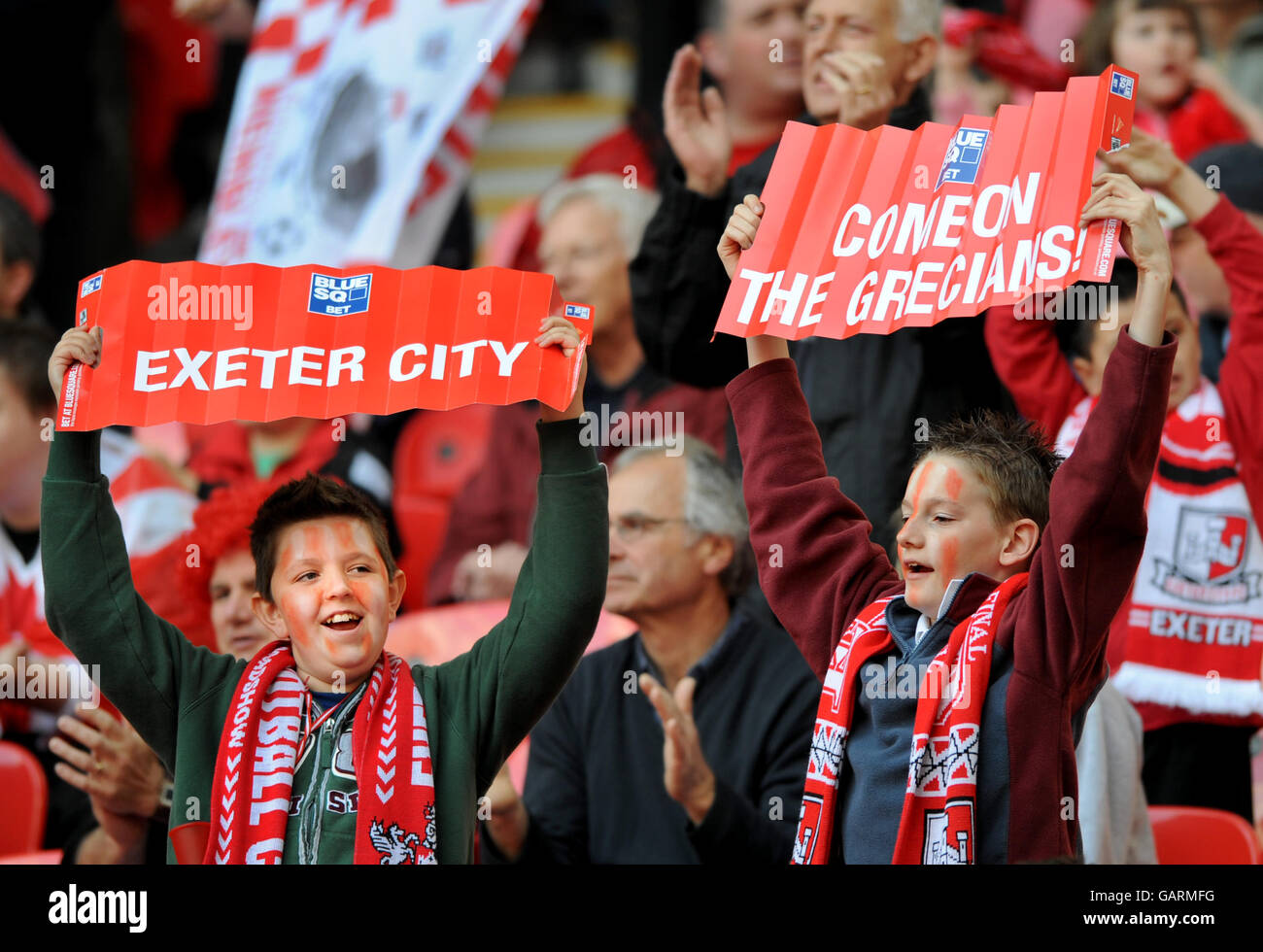 Two Exeter City fans show their support and colours in the stands ...