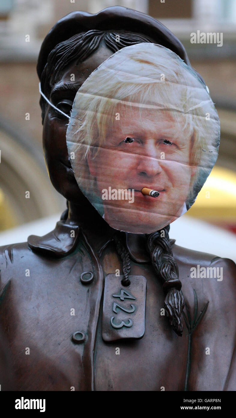 A statue outside Liverpool Street station is defaced with a cut out of ...