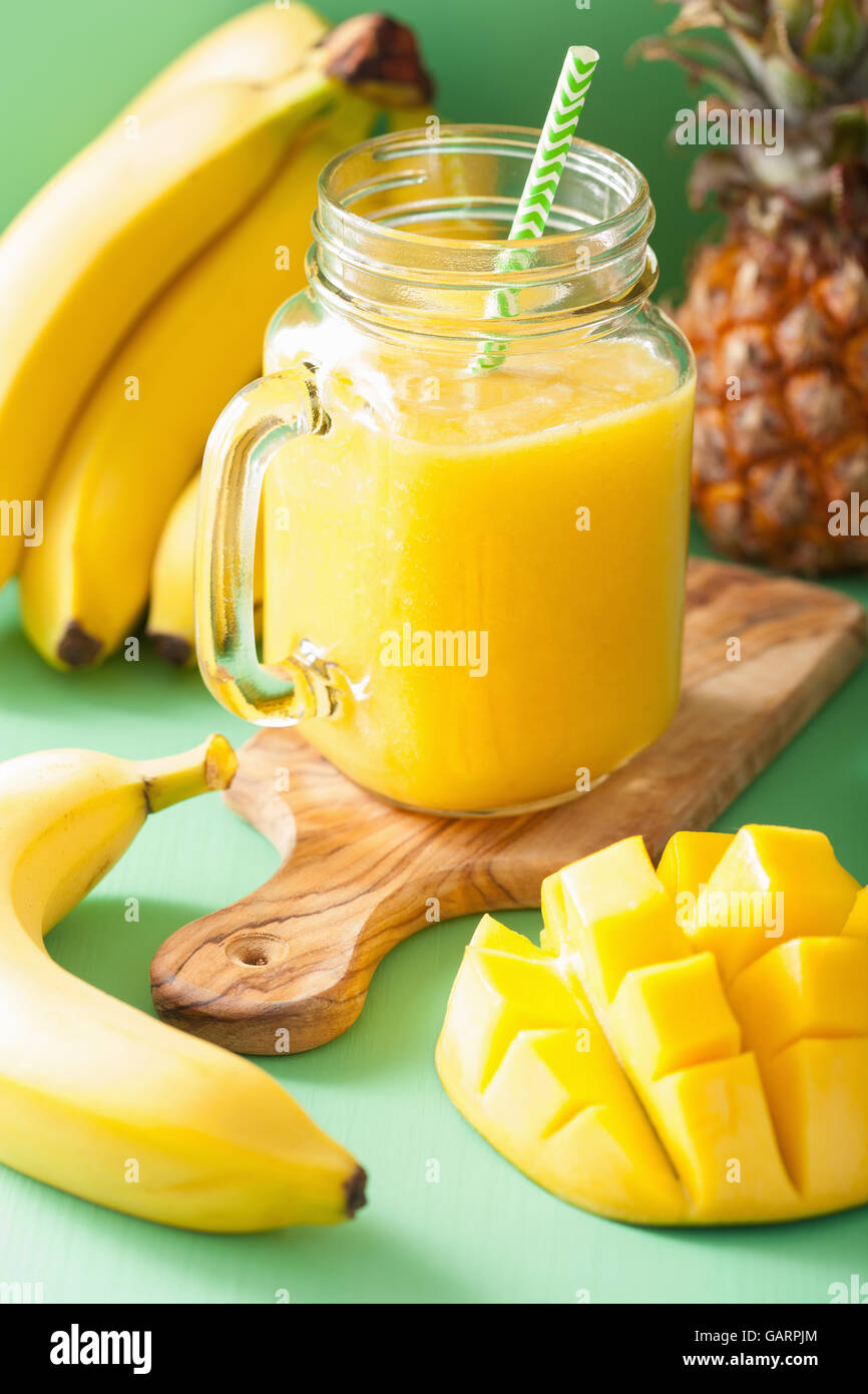healthy yellow smoothie with mango pineapple banana in mason jars Stock ...