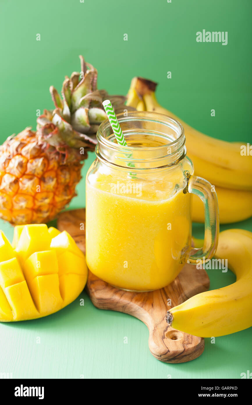 healthy yellow smoothie with mango pineapple banana in mason jars Stock ...