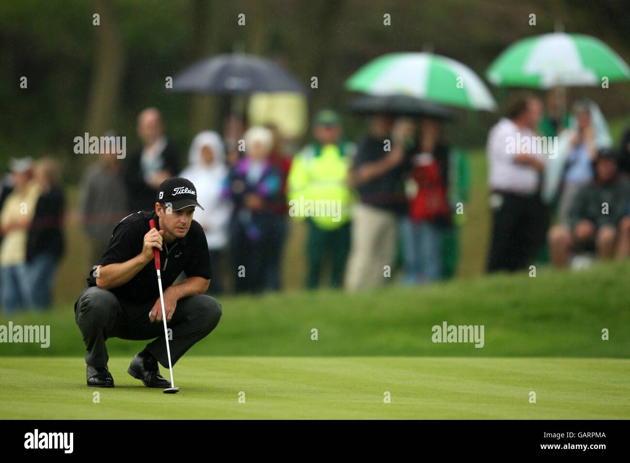 Scott Strange lines up his putt on the 18th green before winning the ...
