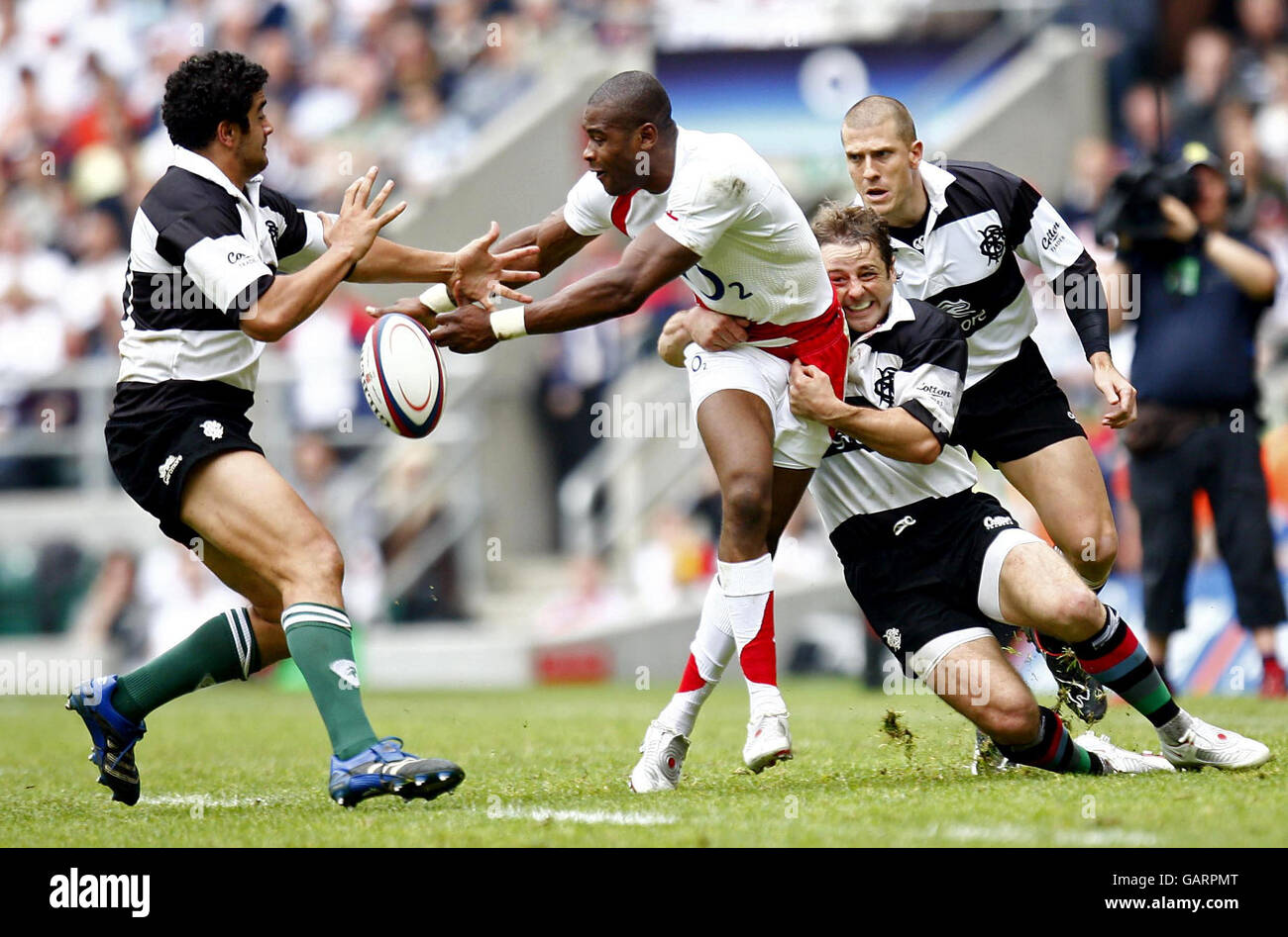 England's Ugo Monye is tackeld by Barbarian's Andy Gomarsall during the ...