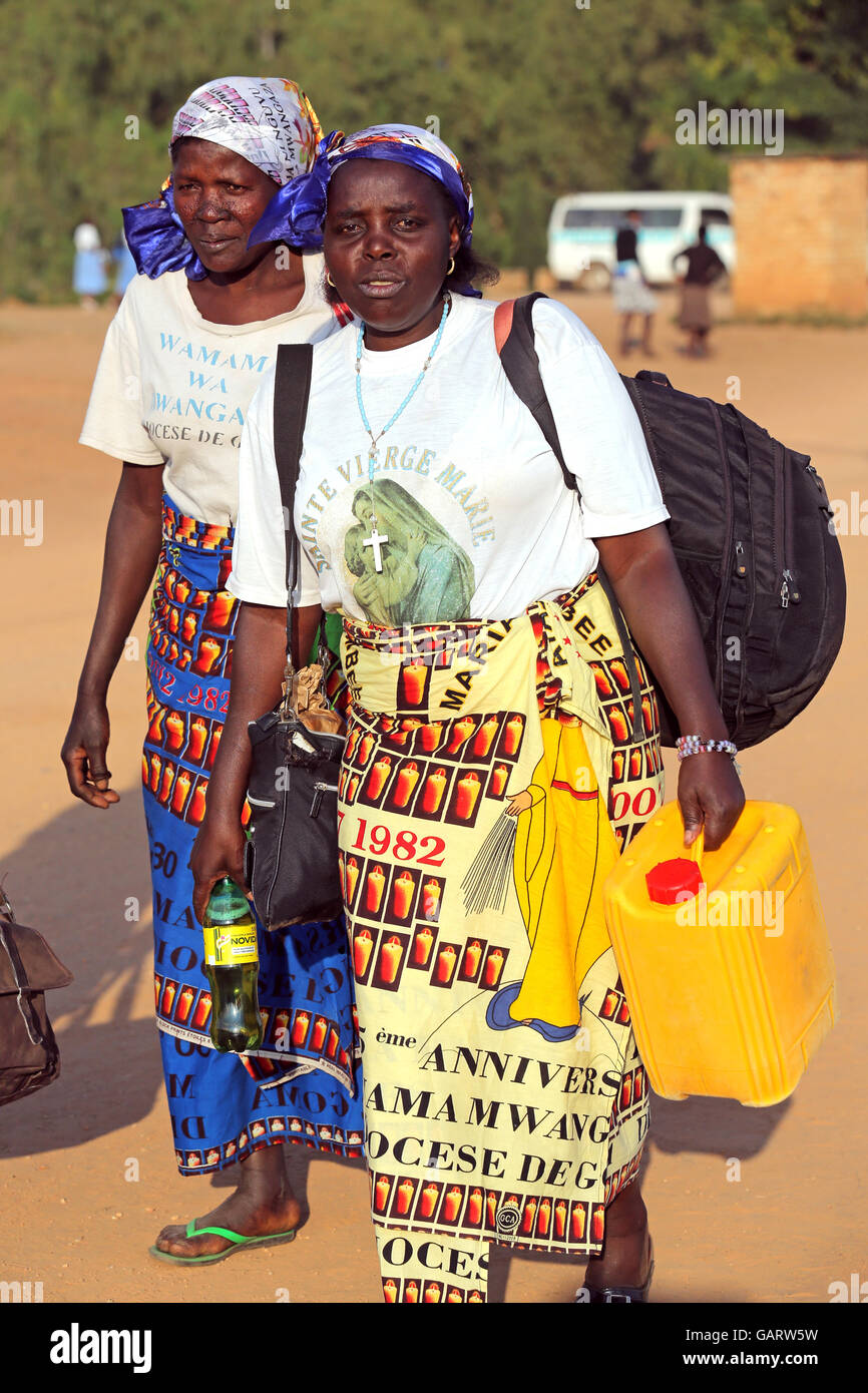 Pilgrims from Congo carry containers of holy water at the pilgrimage ...