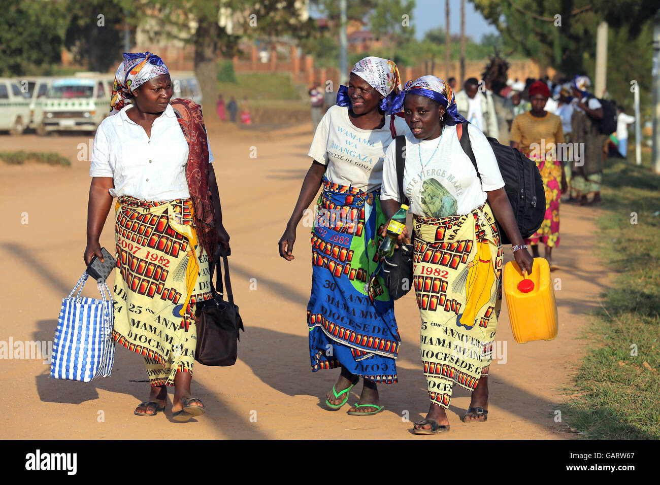 Pilgrims from Congo carry containers of holy water at the pilgrimage ...