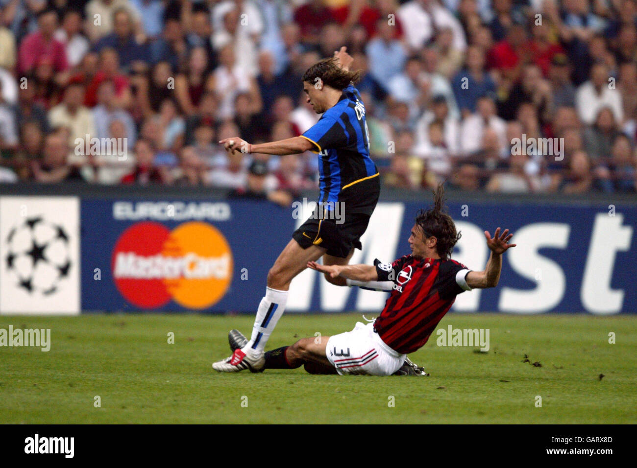 (L-R) AC Milan's Paolo Maldini slide tackles Inter Milan's Hernan ...