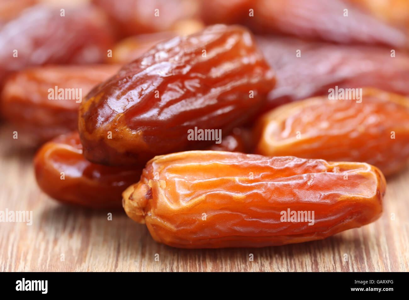 Arabian Dates on wooden surface Stock Photo - Alamy