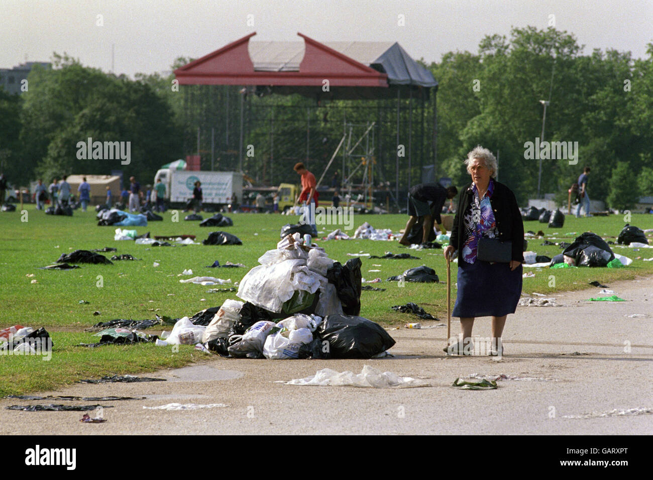 A woman strolls through the middle of the clean up operation in Hyde ...