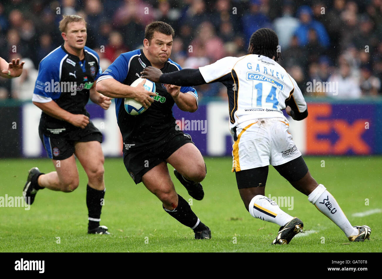 Bath's Lee Mears steps inside a tackle by Worcester's Marcel Garvey ...