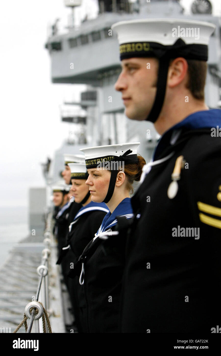 Sailors line the flight deck of HMS Illustrious as she returns to ...