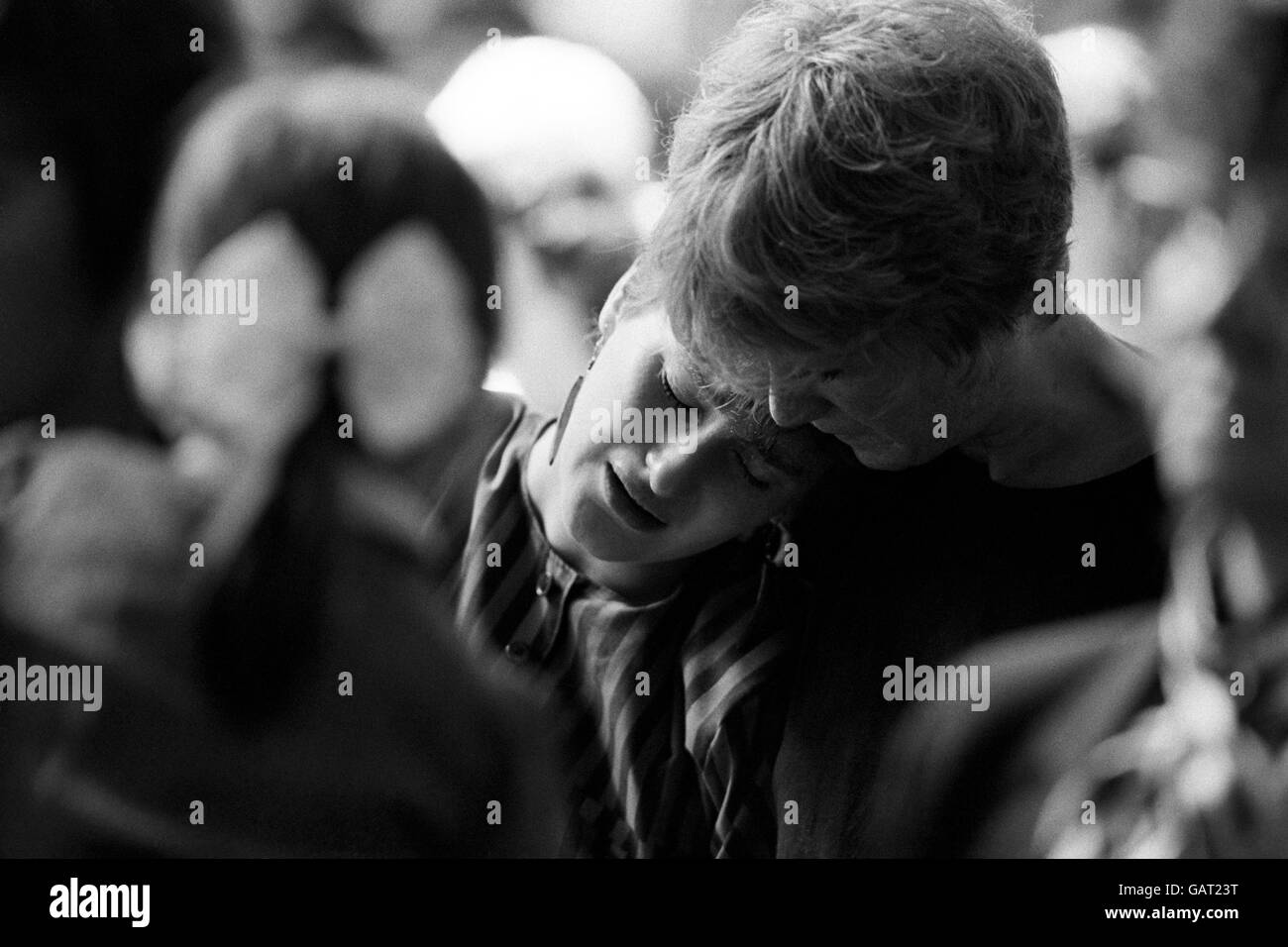 Two women share their grief during today's requiem mass at St. Mary's ...