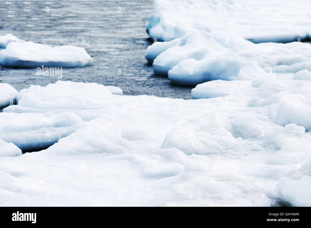 Natural sea ice blocks breaking up against shore and ice during ...