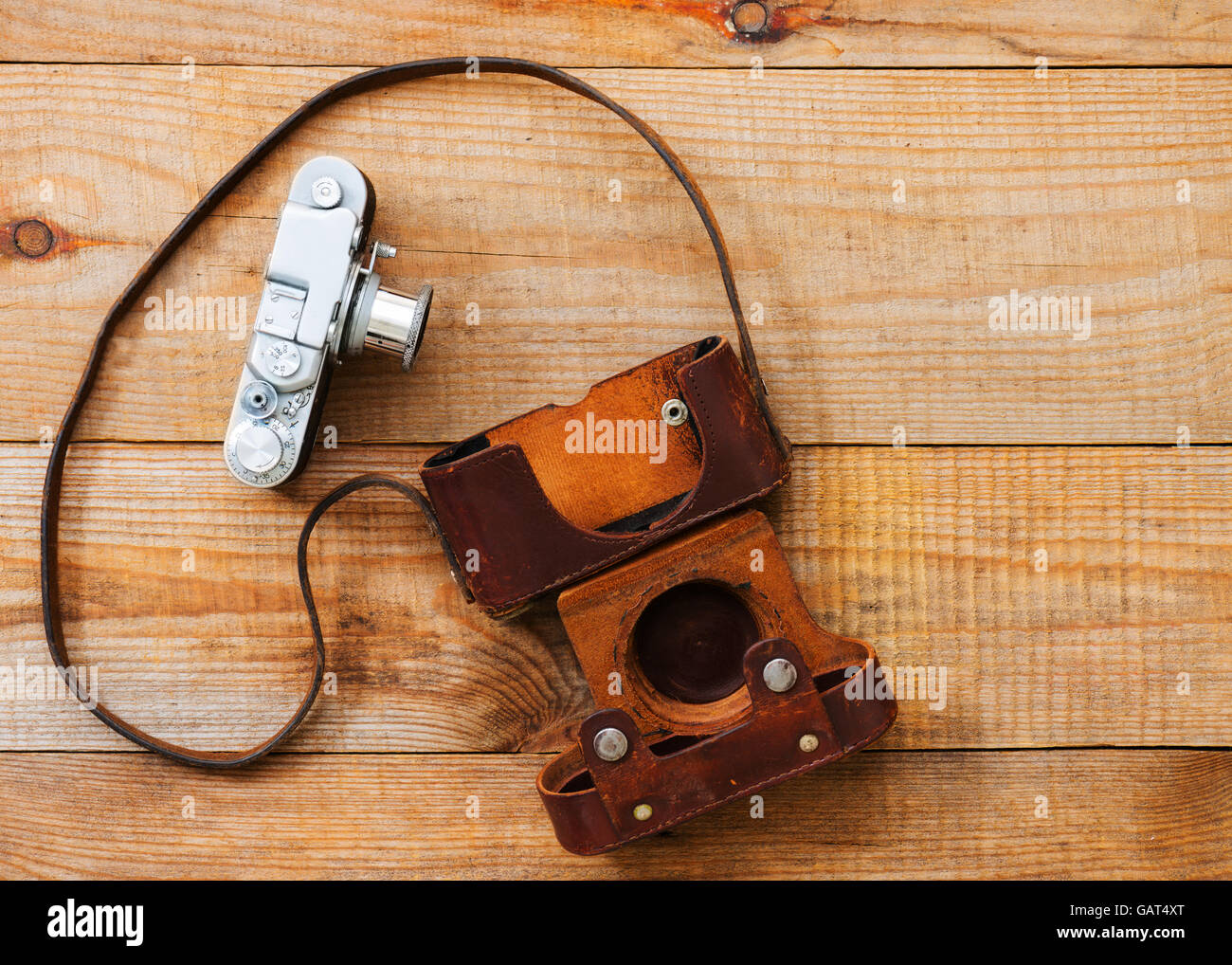 Vintage, very old film camera on brown wooden background and space for ...