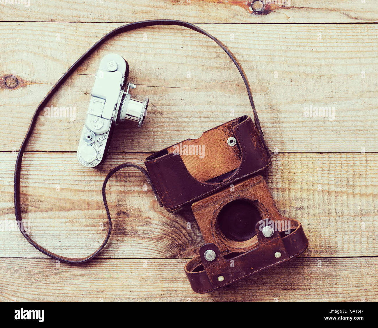Vintage, very old film camera on brown wooden background and space for ...