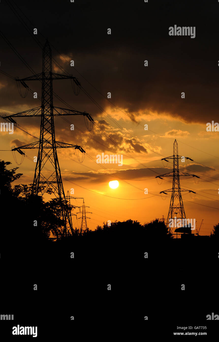Electricity pylons in the sunset hi-res stock photography and images ...