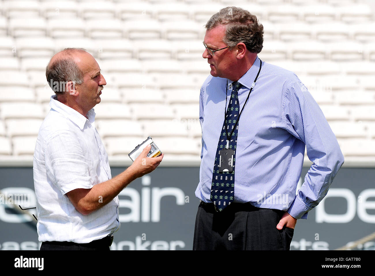 Surrey Chief Executive, Paul Sheldon (r) is interviewed by the media at ...