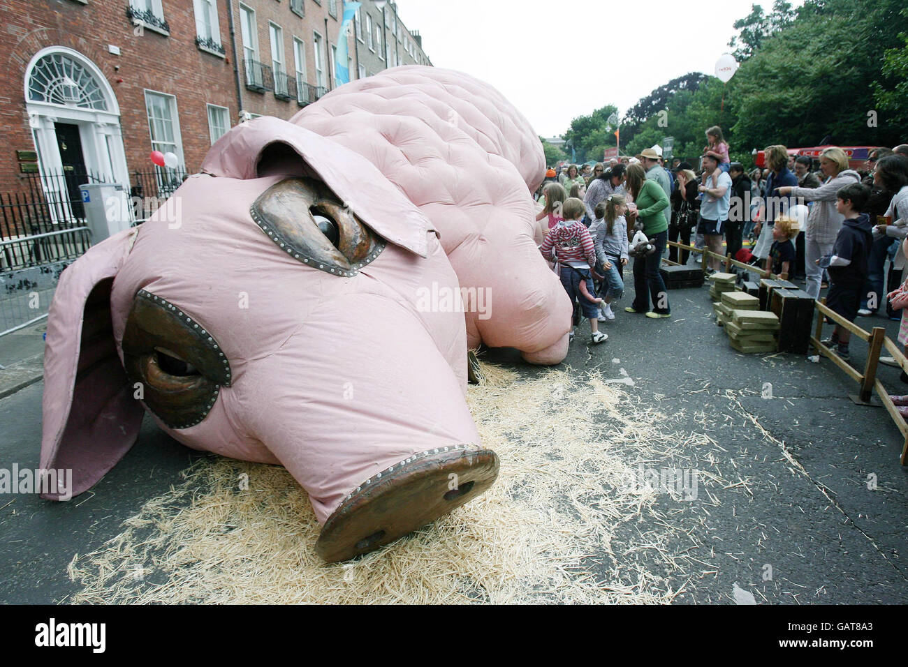 Children stare into a 30 foot long pig which forms one of the ...