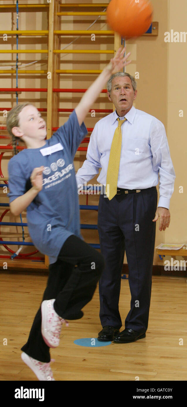 US president George Bush plays basketball with members of the ...