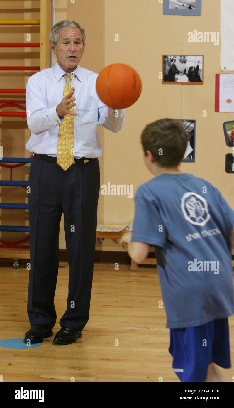US president George Bush plays basketball with members of the ...