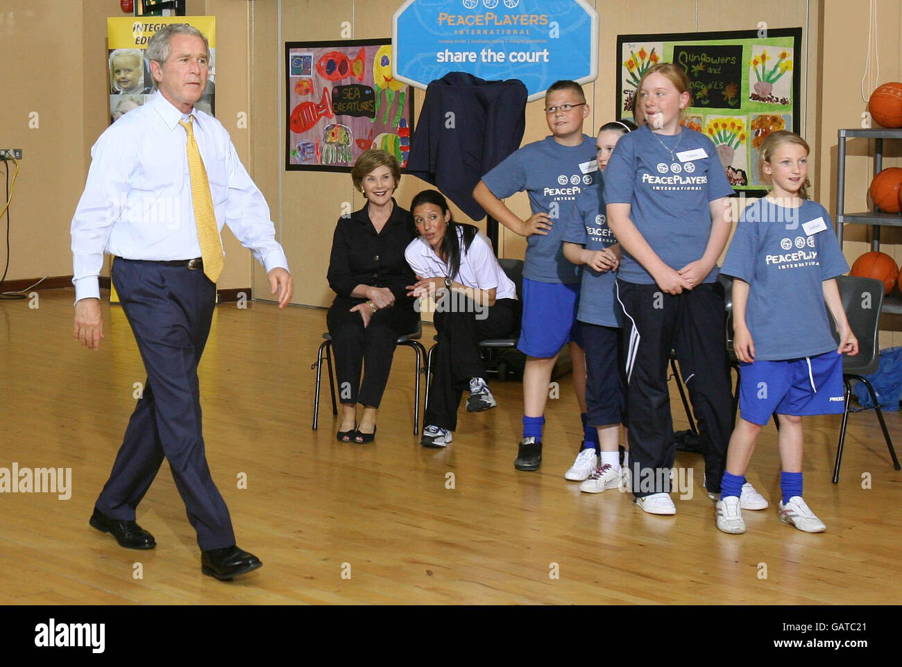 US president George Bush plays basketball with members of the ...