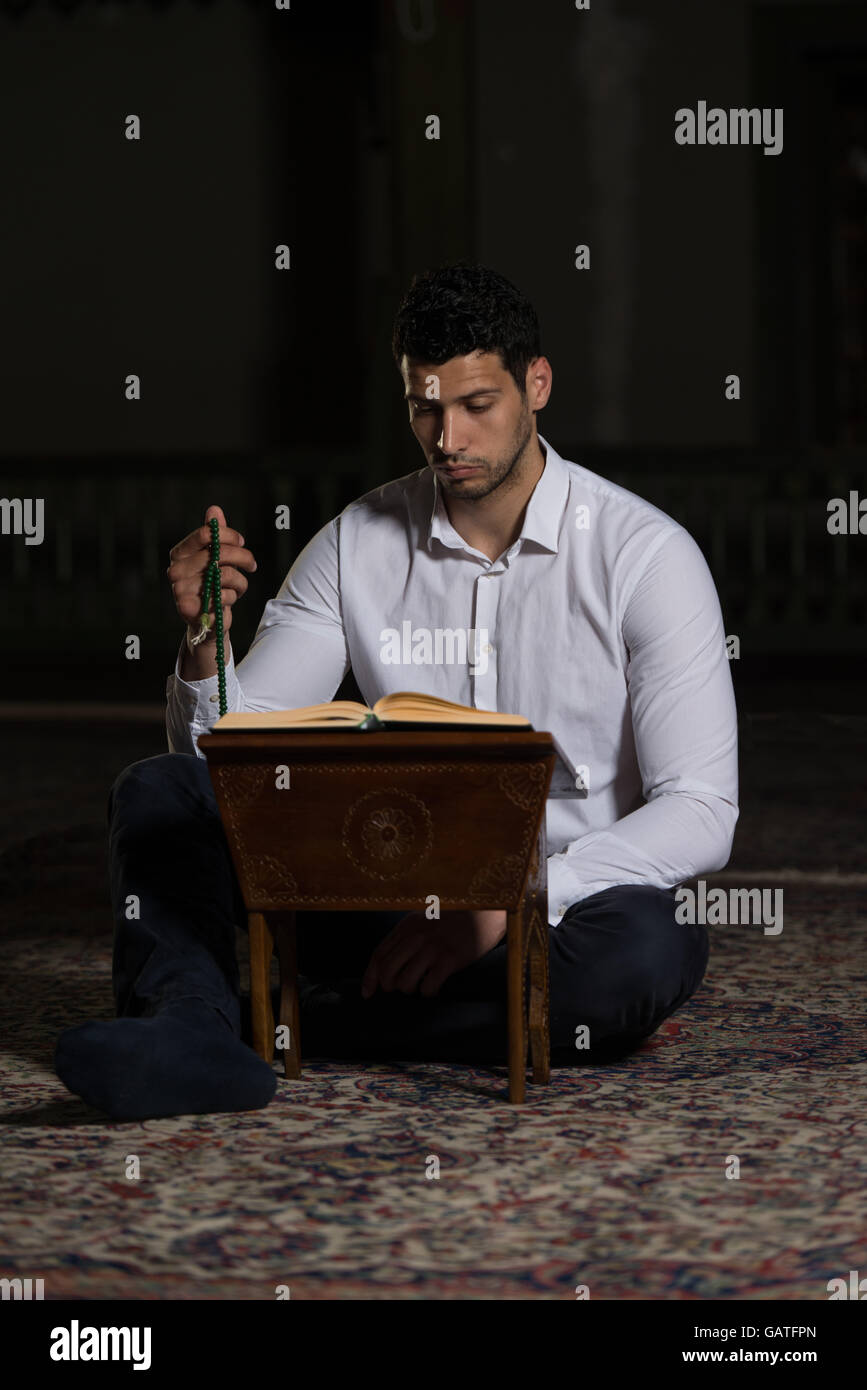 Adult Muslim Man Is Reading The Koran In The Mosque Stock Photo - Alamy