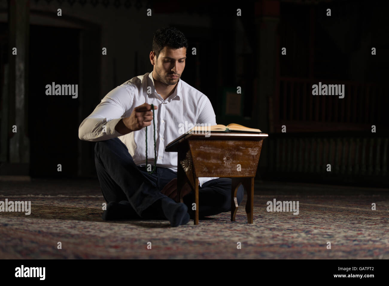 Adult Muslim Man Is Reading The Koran In The Mosque Stock Photo - Alamy