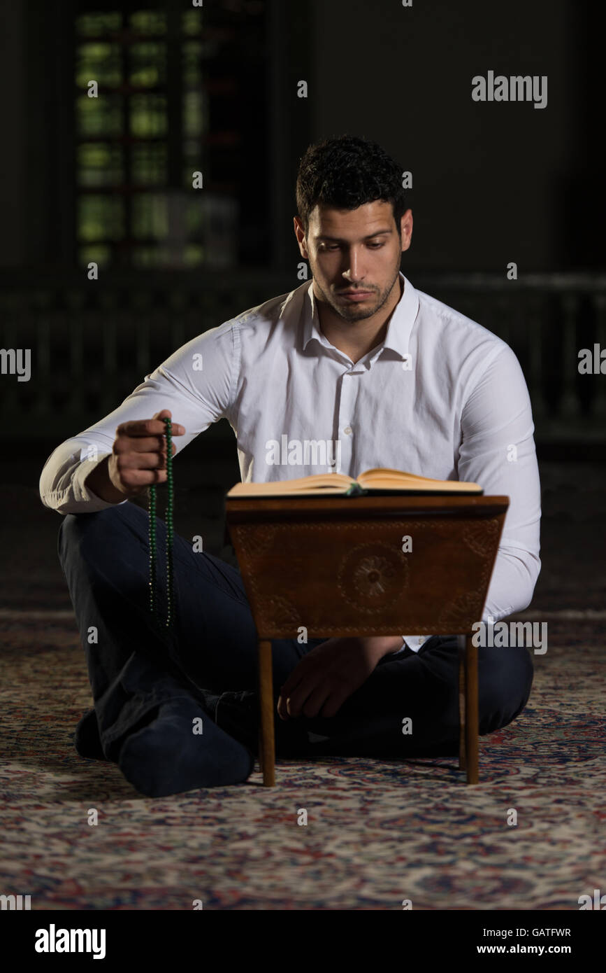 Adult Muslim Man Is Reading The Koran In The Mosque Stock Photo - Alamy