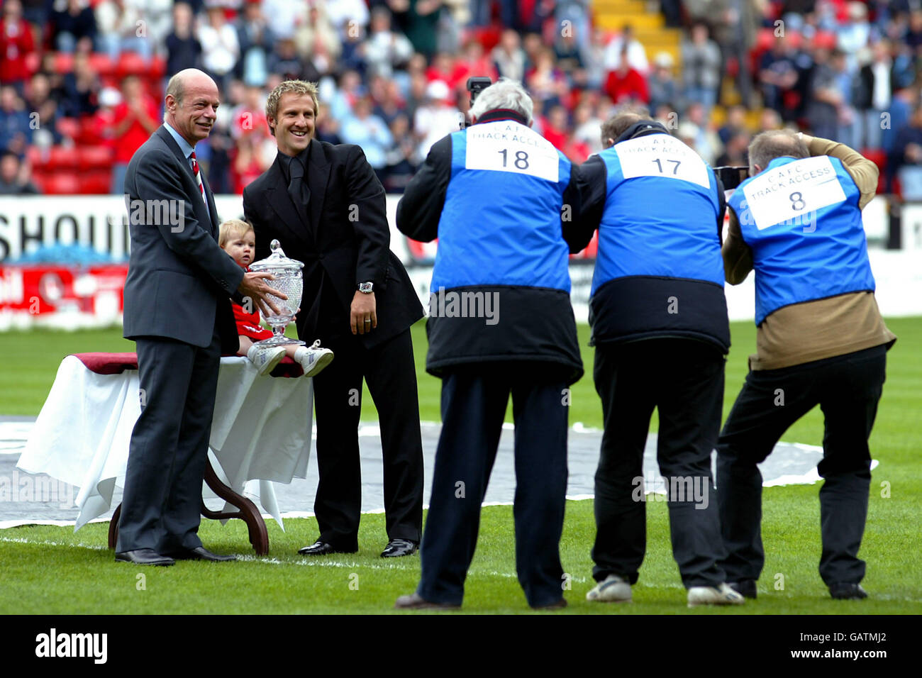 Charlton Athletic's John Robinson is presented with a commemorative ...