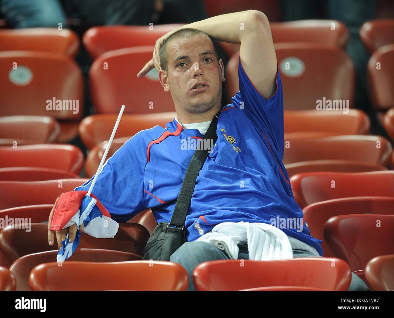 French fans are left dejected after the final whistle as they crash out ...