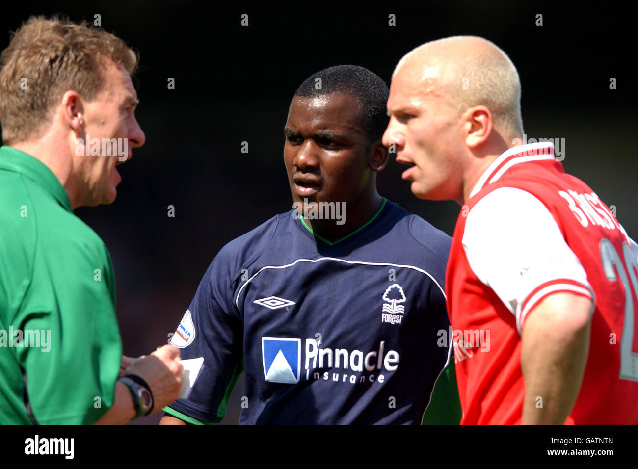 Referee Paul Taylor lectures Rotherham United's Guy Branston (r) and ...