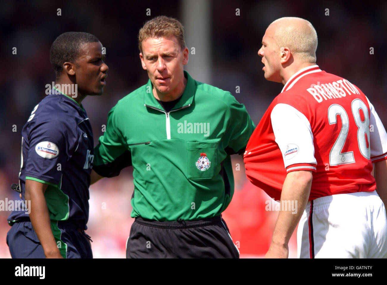 Referee Paul Taylor comes between Rotherham United's Guy Branston (r ...