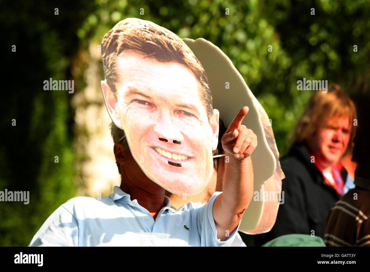 A fan with the face mask of Worcestershire Royals' Graeme Hick watches ...
