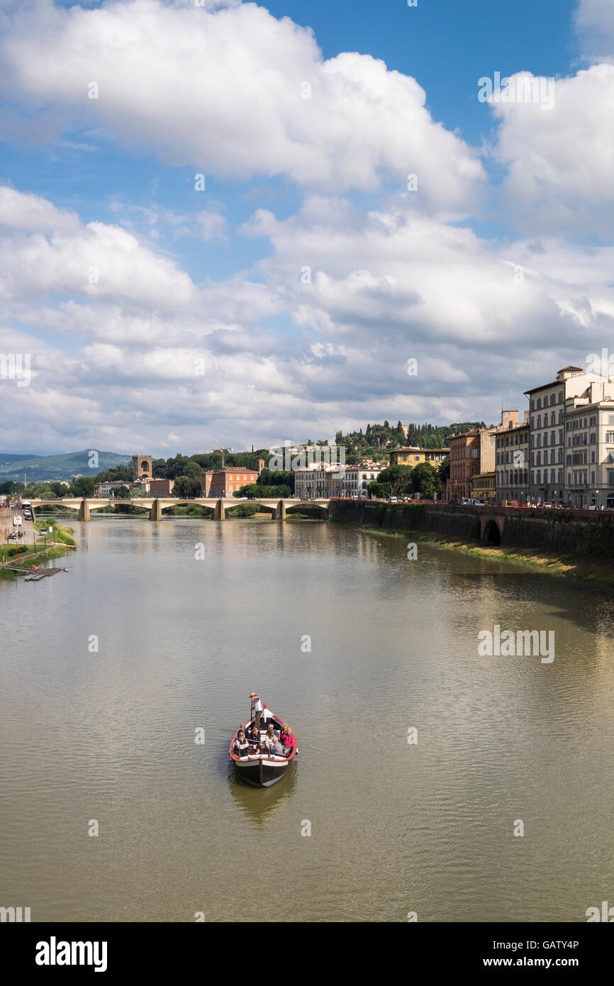 Boat trip with tourists on the River Arno in Florence, Tuscany, Italy ...