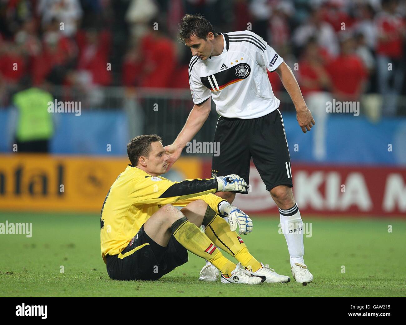 Germany's Miroslav Klose consoles Austria's Jurgen Macho after the ...