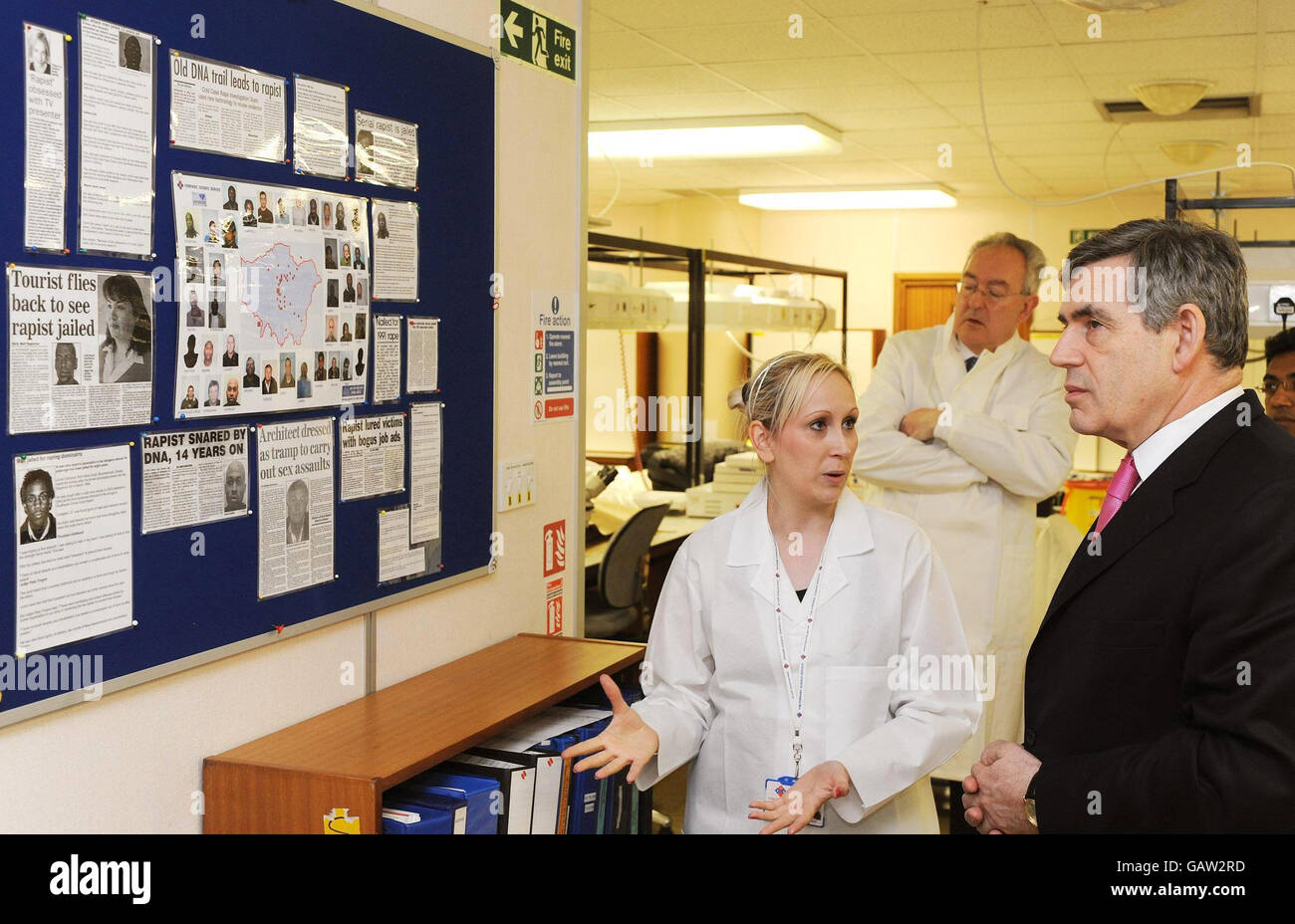The Prime Minister Gordon Brown looks at paper cuttings of crimes ...
