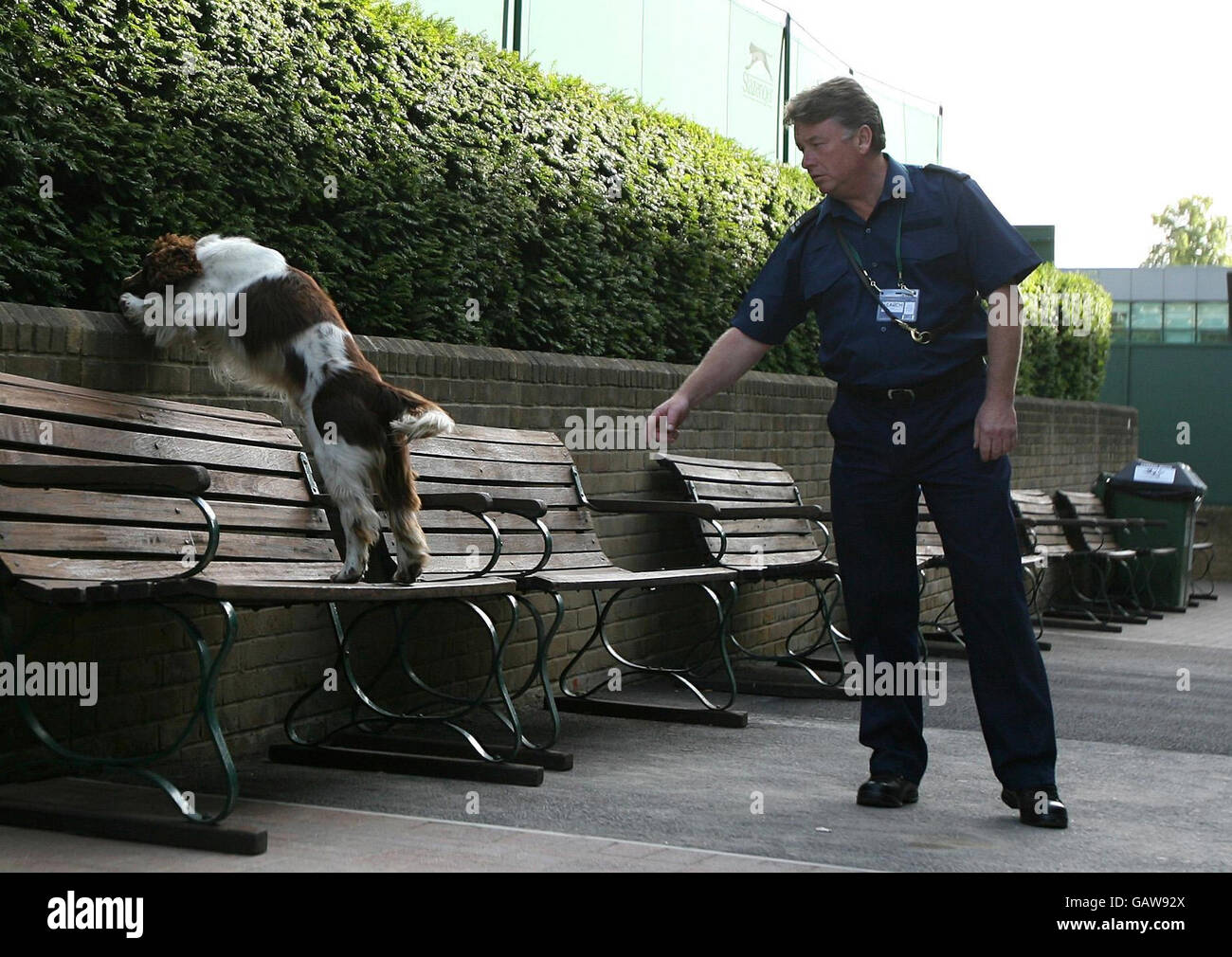 Security wth dogs search the grounds before The Wimbledon Championships ...
