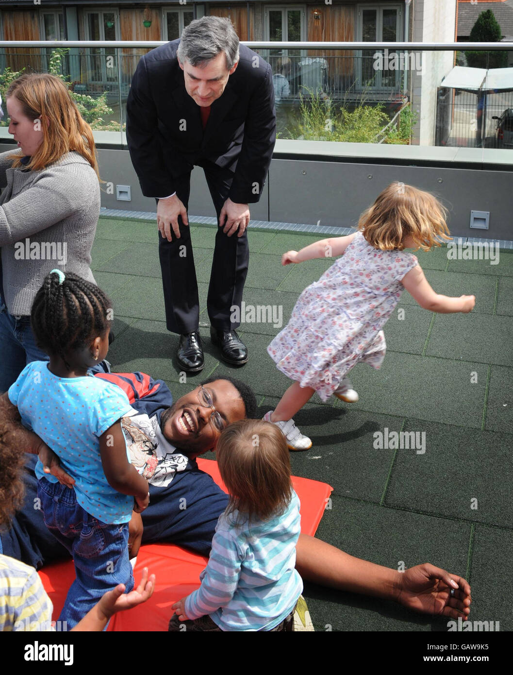 Prime Minister Gordon Brown (standing) meets children and staff at the ...