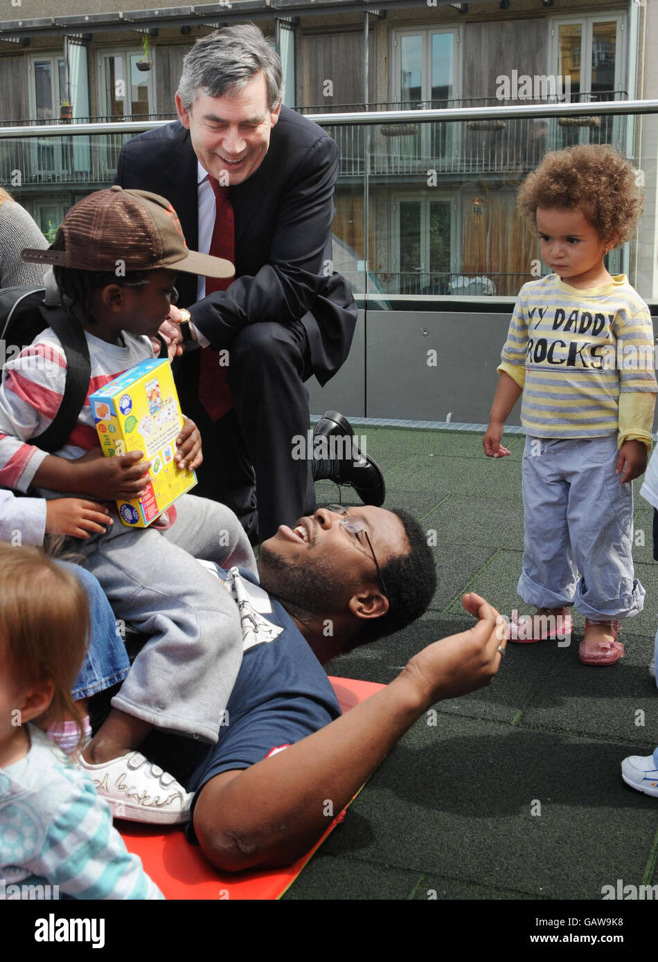 Prime Minister Gordon Brown (back) meets children and staff at the Coin ...