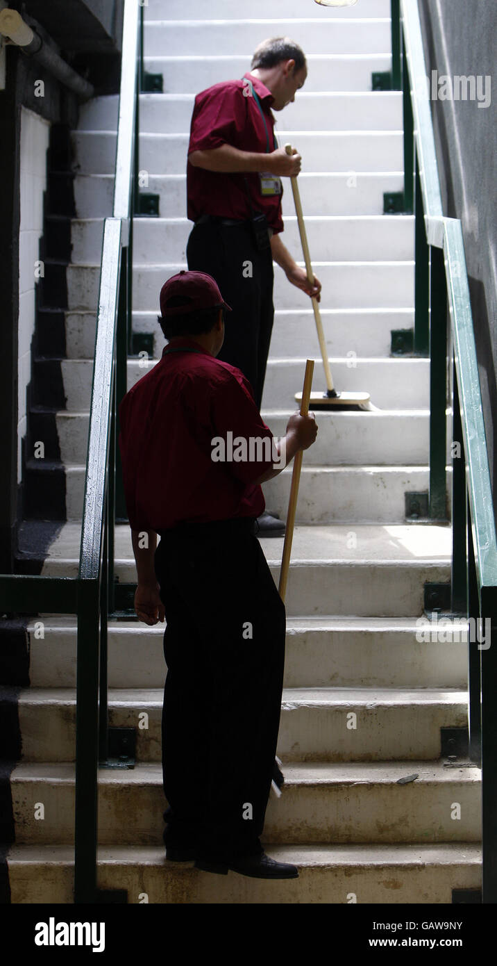 Workers sweep the stairs during the Wimbledon Championships 2008 at the ...