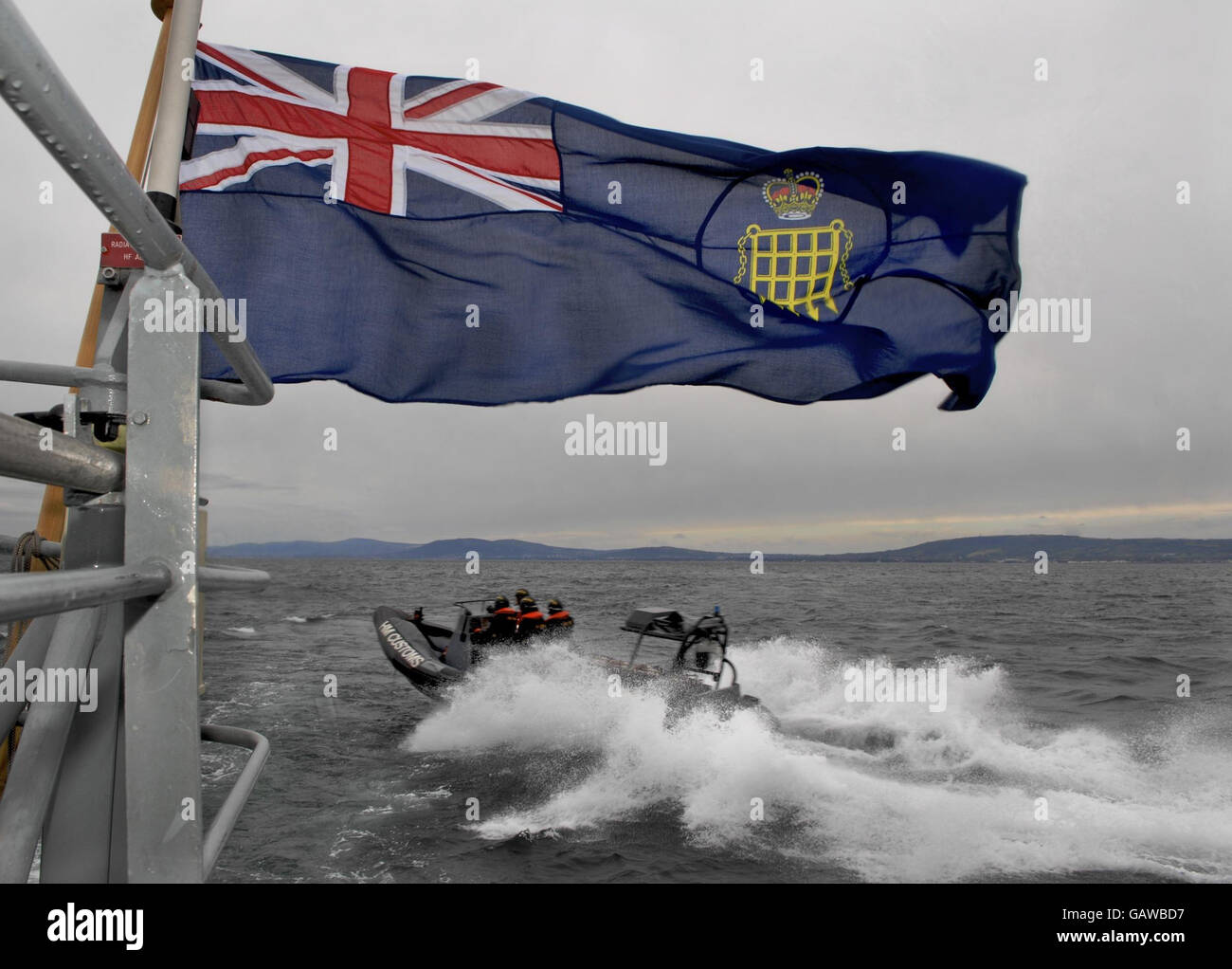 A flag flies above the HM Customs Cutter SEEKER during an exercise on ...
