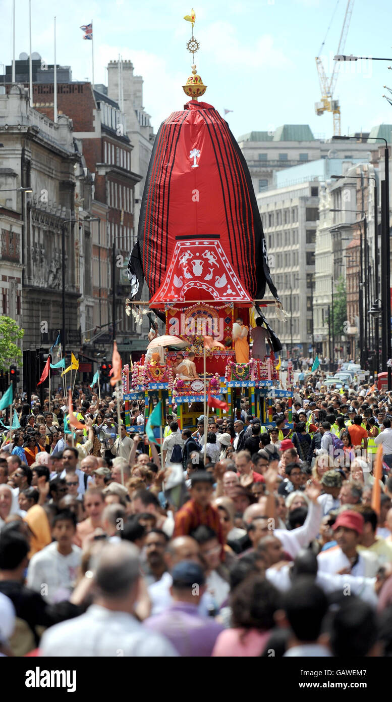 One of three 40 foot high wooden chariots is pulled by hand along ...