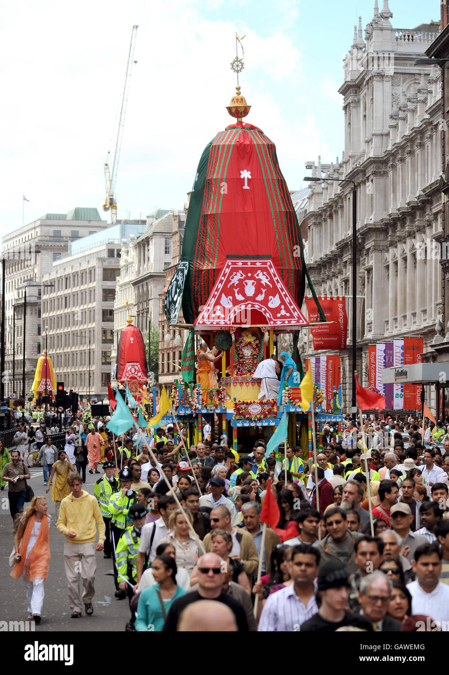 Three 40 foot high wooden chariots are pulled by hand along Piccadilly ...
