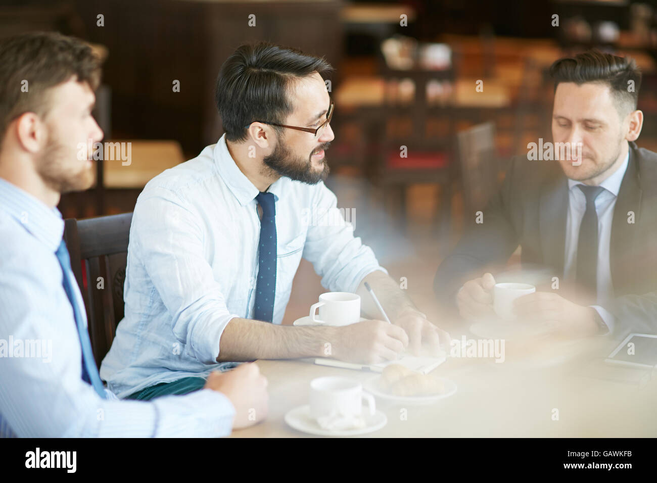 Group of entrepreneurs brainstorming about new project with partners in ...